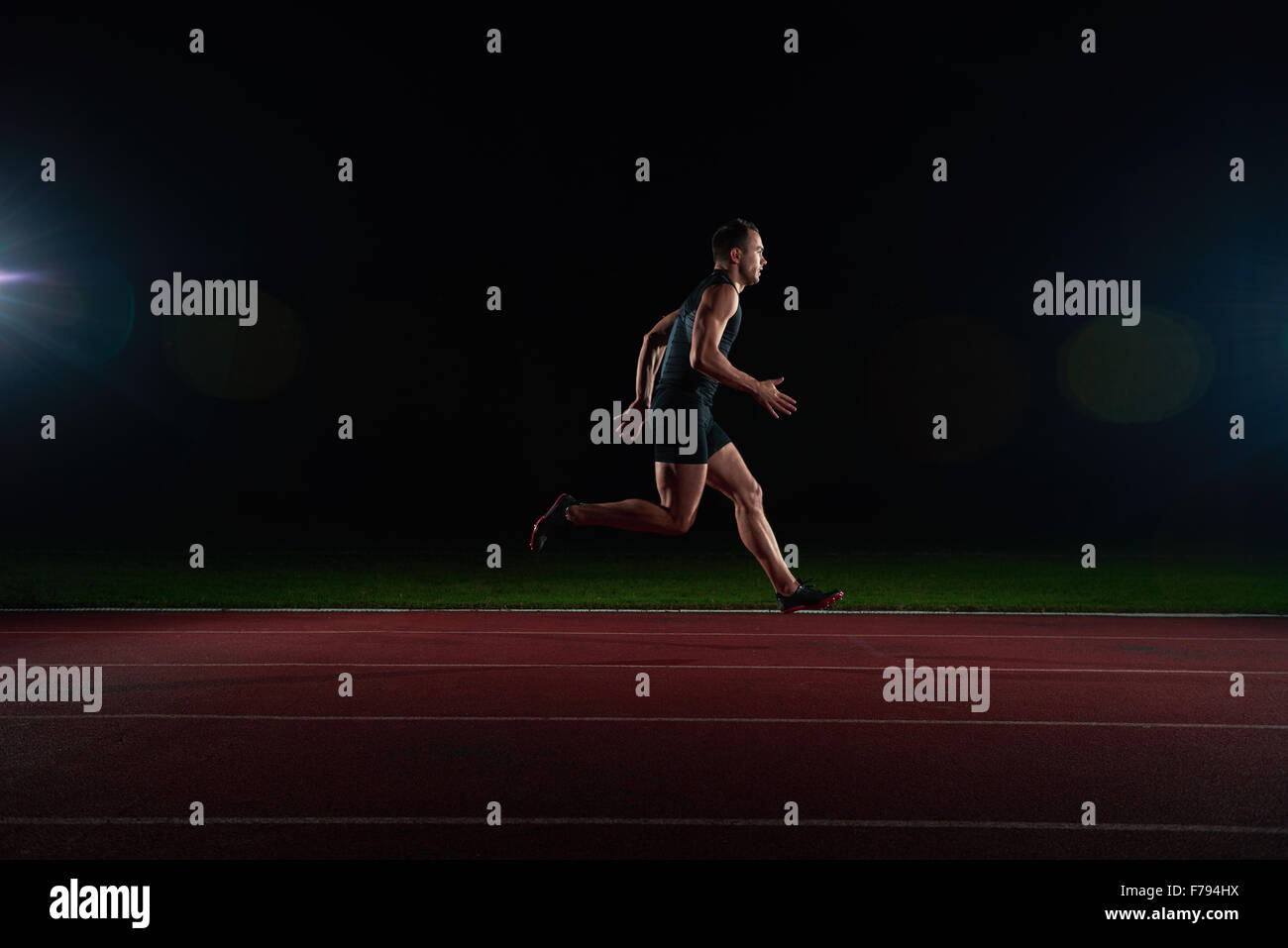 Sprinter leaving starting blocks on the running track. Explosive start ...