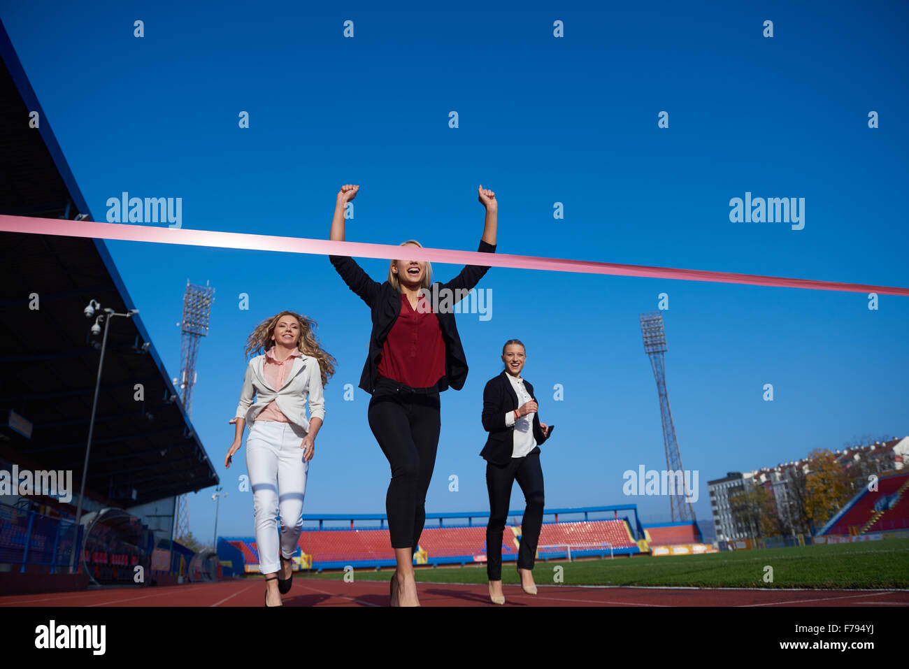 business people running together on racing track Stock Photo - Alamy
