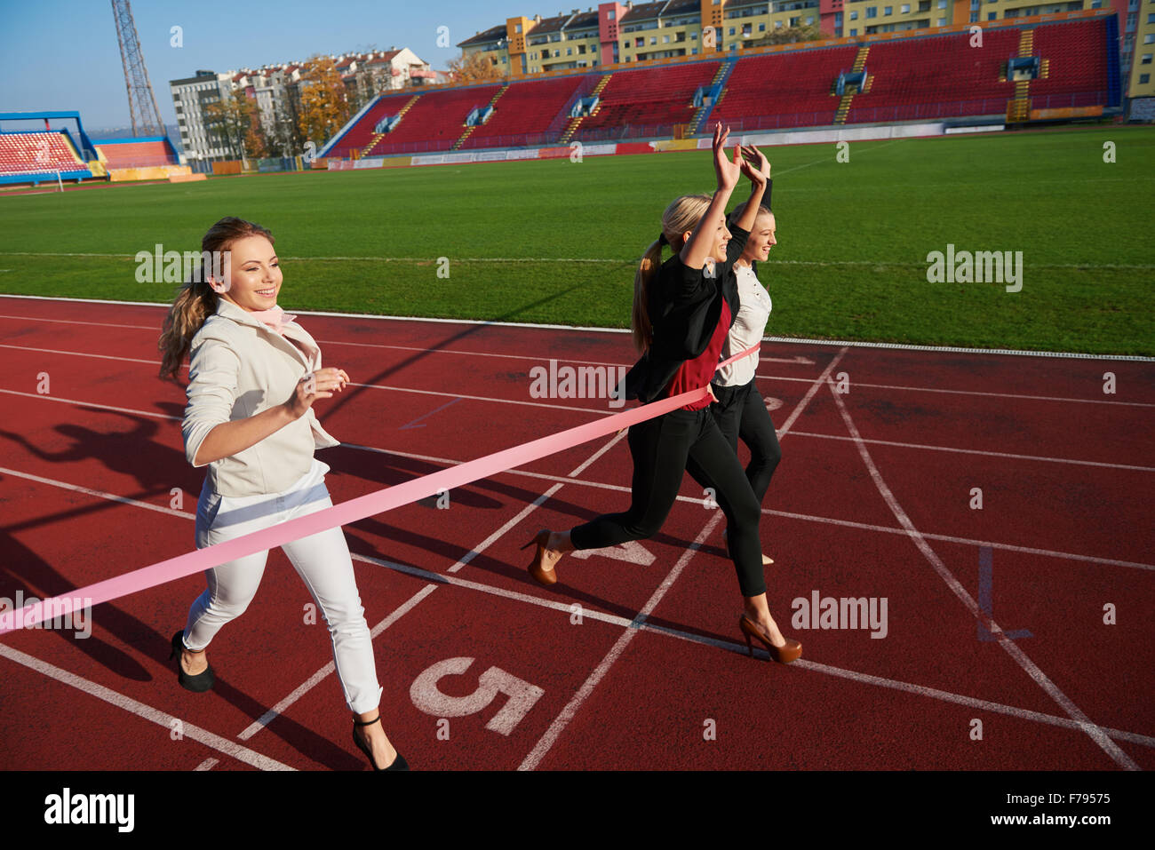 business people running together on racing track Stock Photo - Alamy