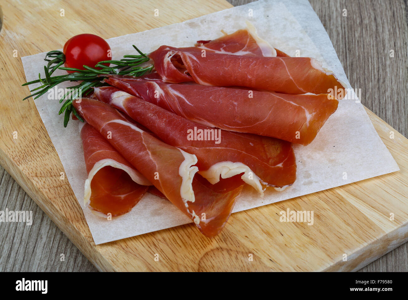 Spanish traditional snack - Jamon with tomato and rosemary Stock Photo ...