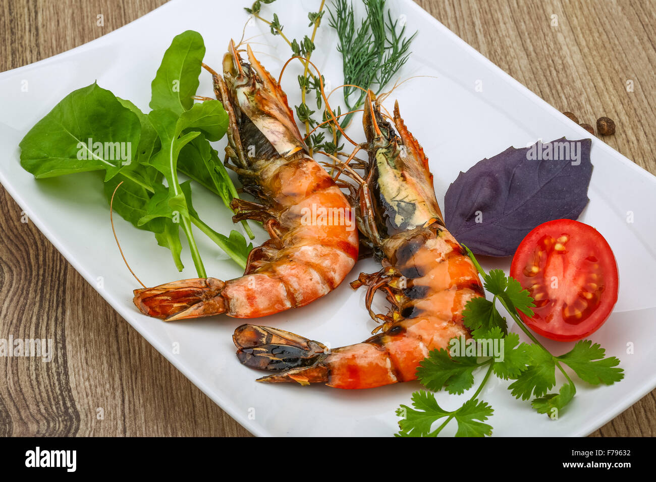 Roasted tiger shrimps with thyme and basil leaves Stock Photo - Alamy