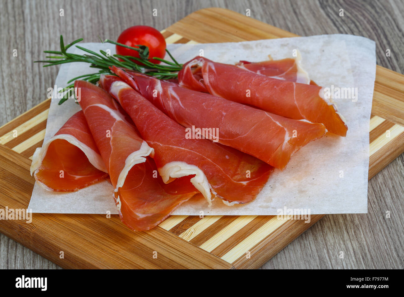 Spanish traditional snack - Jamon with tomato and rosemary Stock Photo ...