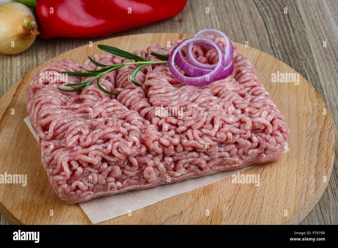 Raw minced pork meat with onion and rosemary ready for cooking Stock ...
