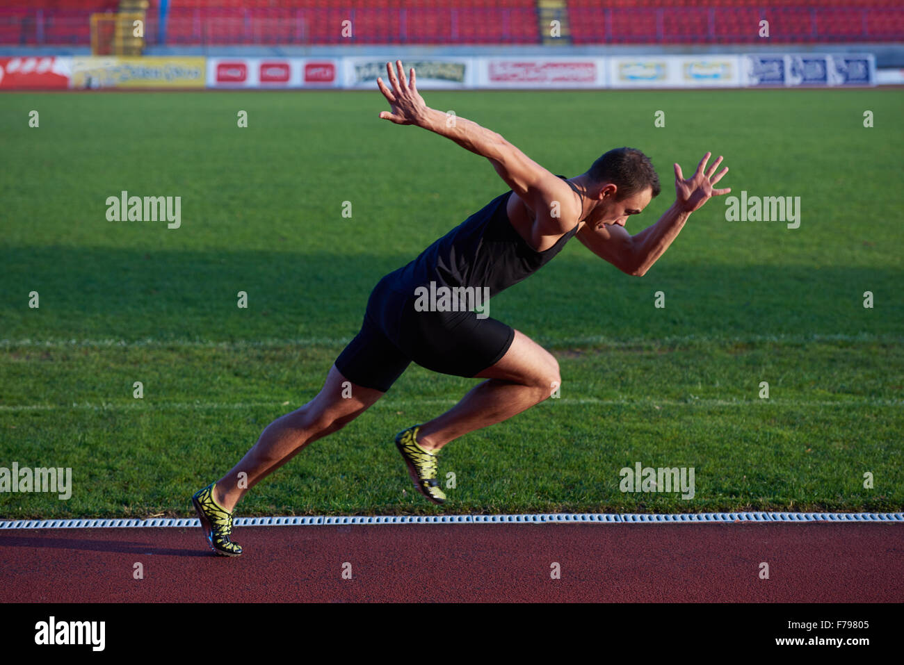 Sprinter leaving starting blocks on the running track. Explosive start ...