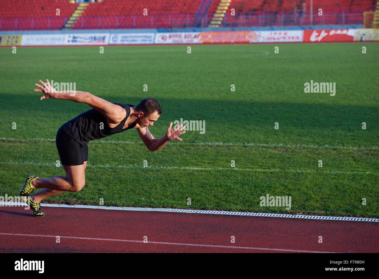 Sprinter leaving starting blocks on the running track. Explosive start ...