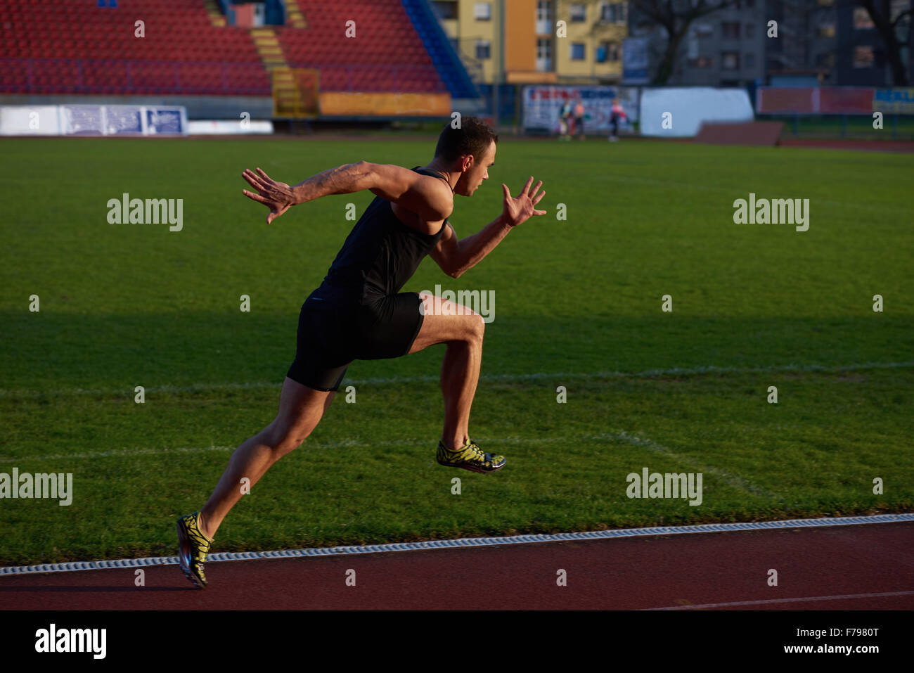 Sprinter leaving starting blocks on the running track. Explosive start ...