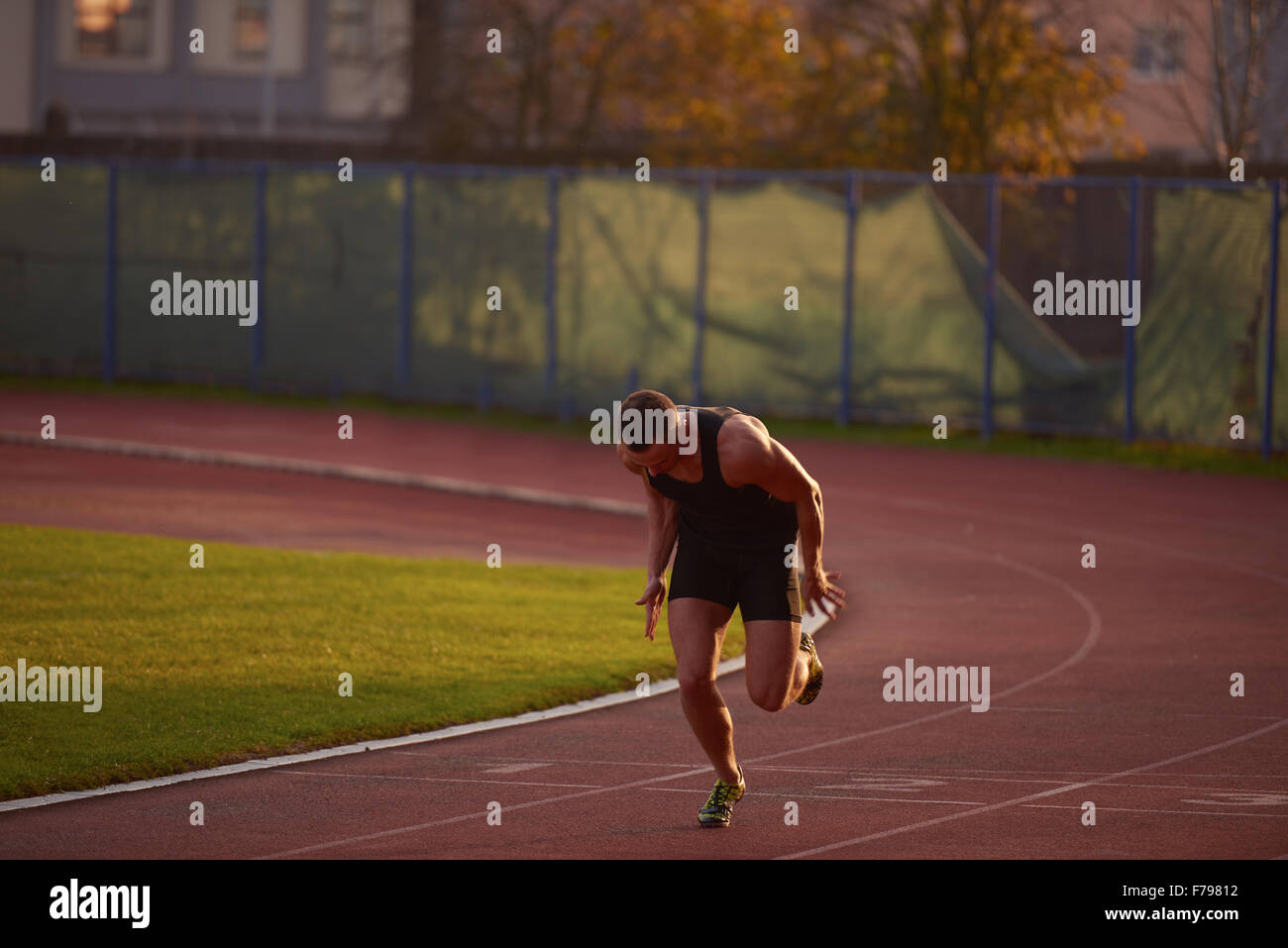 Sprinter leaving starting blocks on the running track. Explosive start ...
