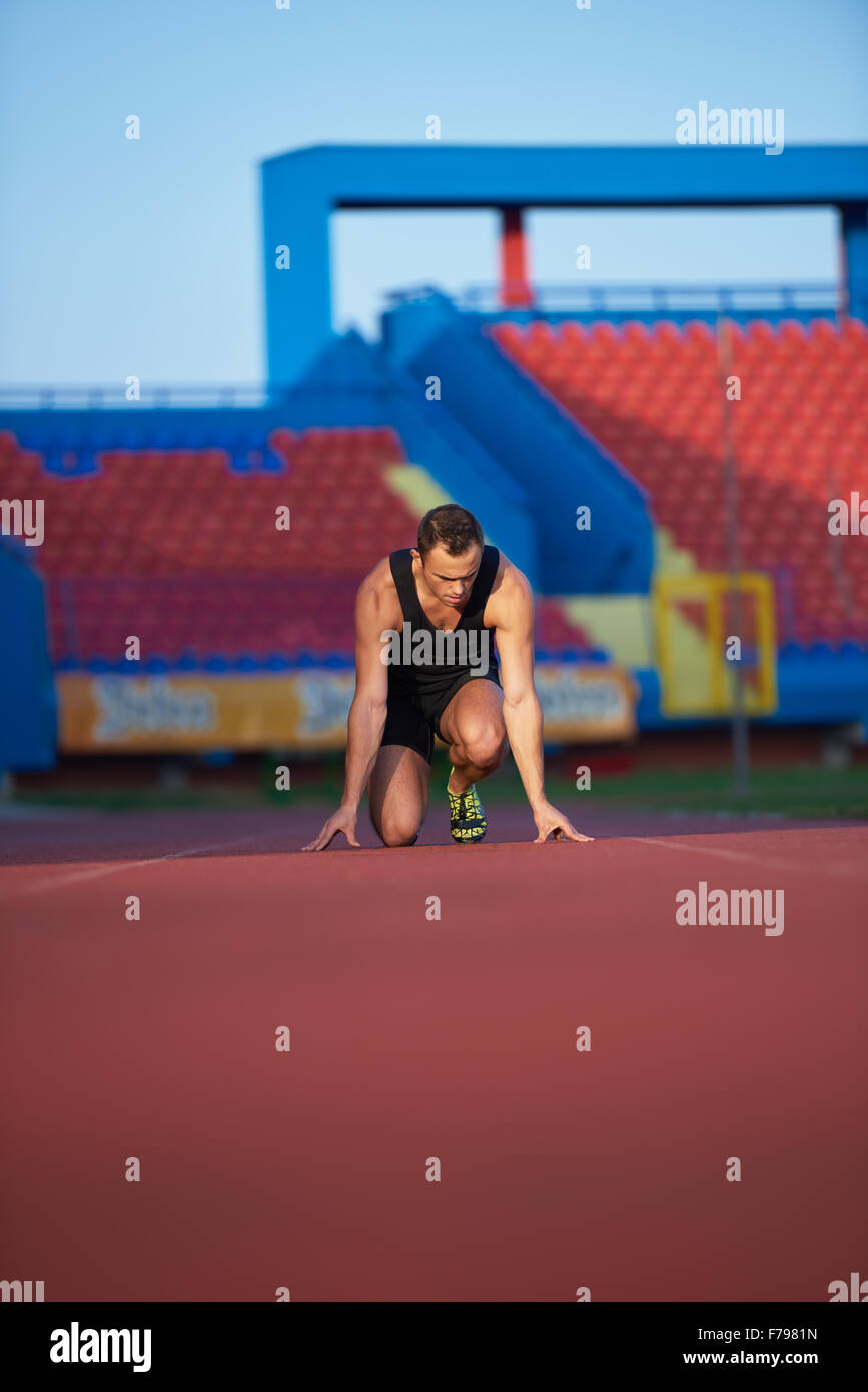 Sprinter leaving starting blocks on the running track. Explosive start ...