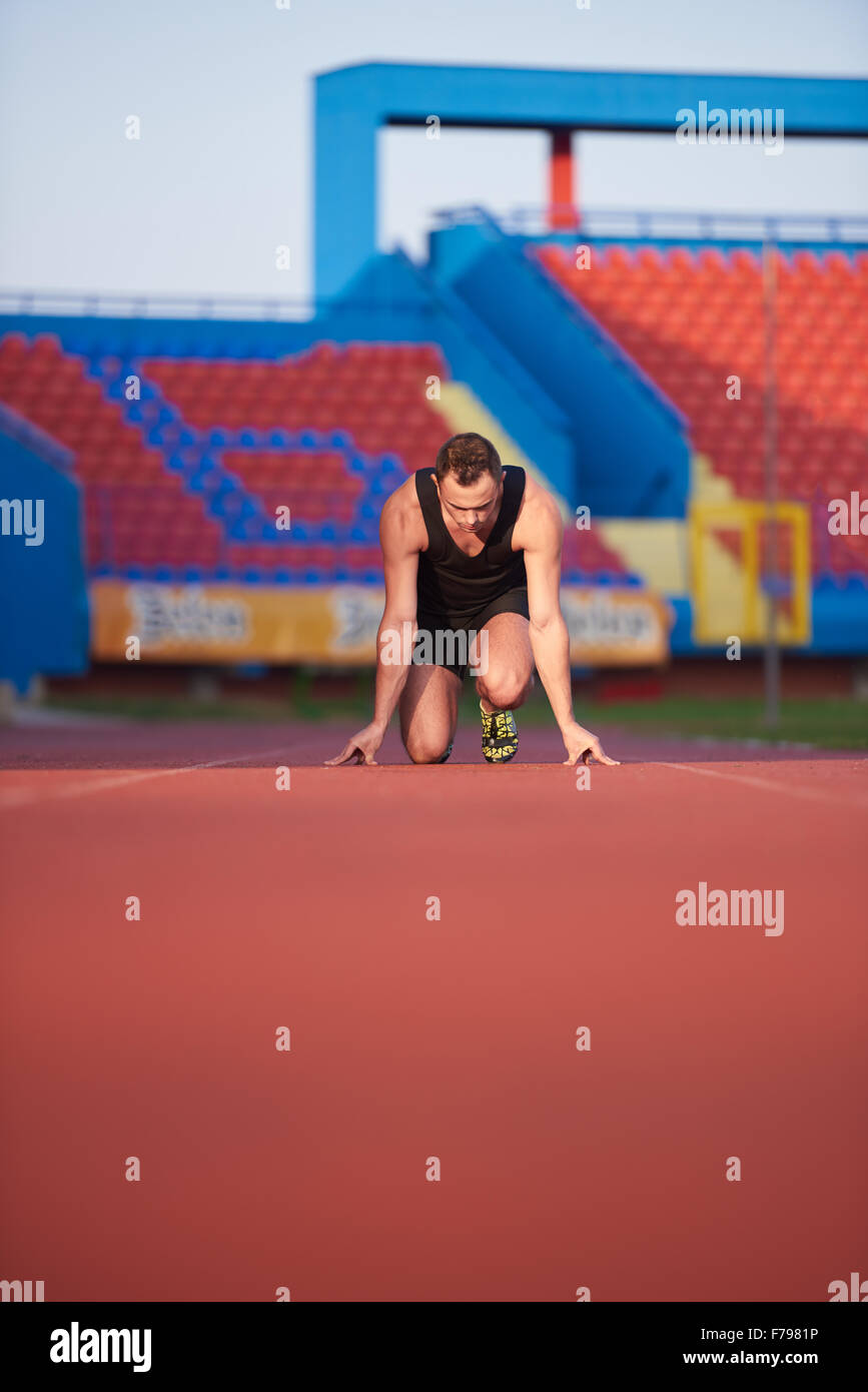 Sprinter leaving starting blocks on the running track. Explosive start ...