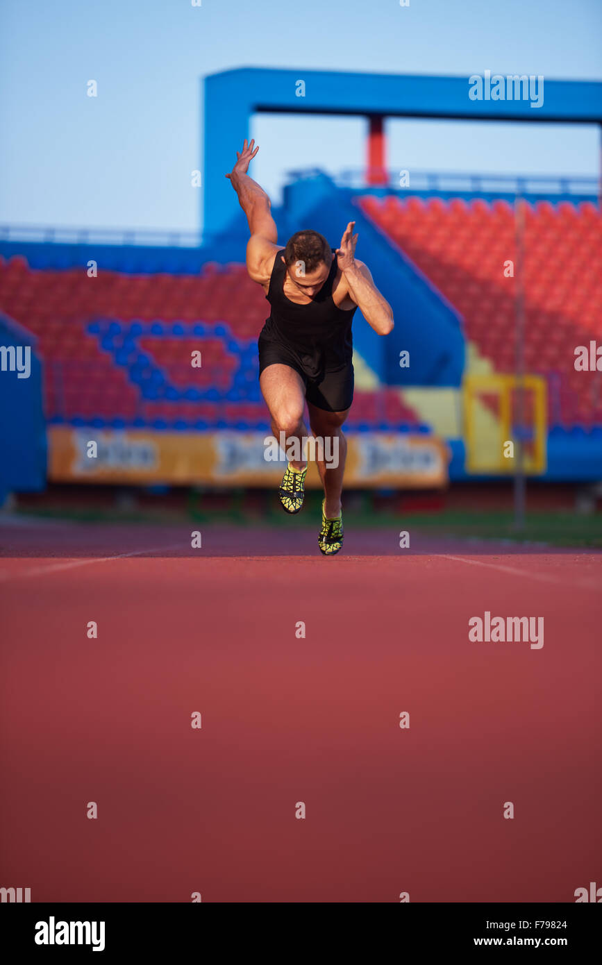Sprinter leaving starting blocks on the running track. Explosive start ...