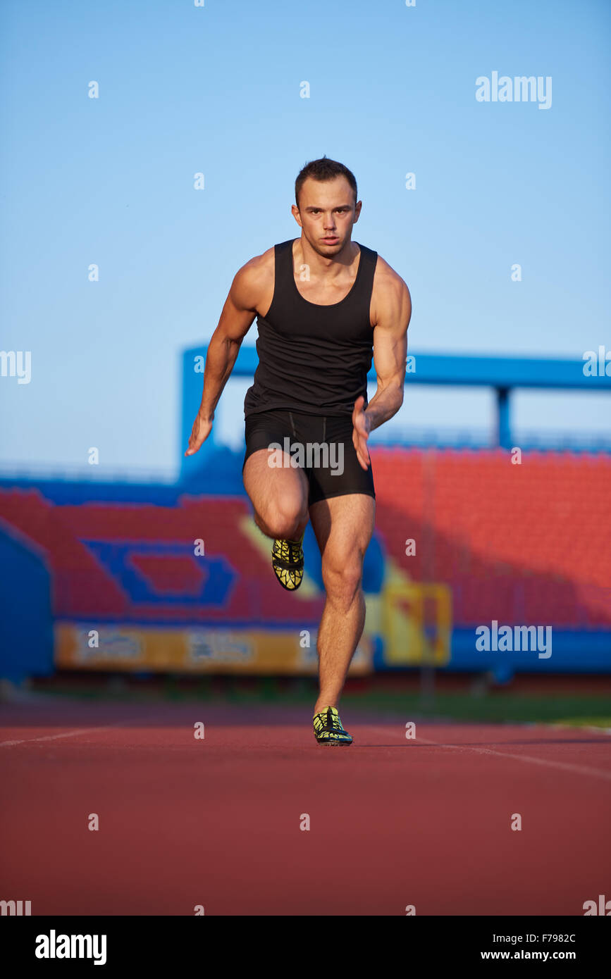 Sprinter leaving starting blocks on the running track. Explosive start ...