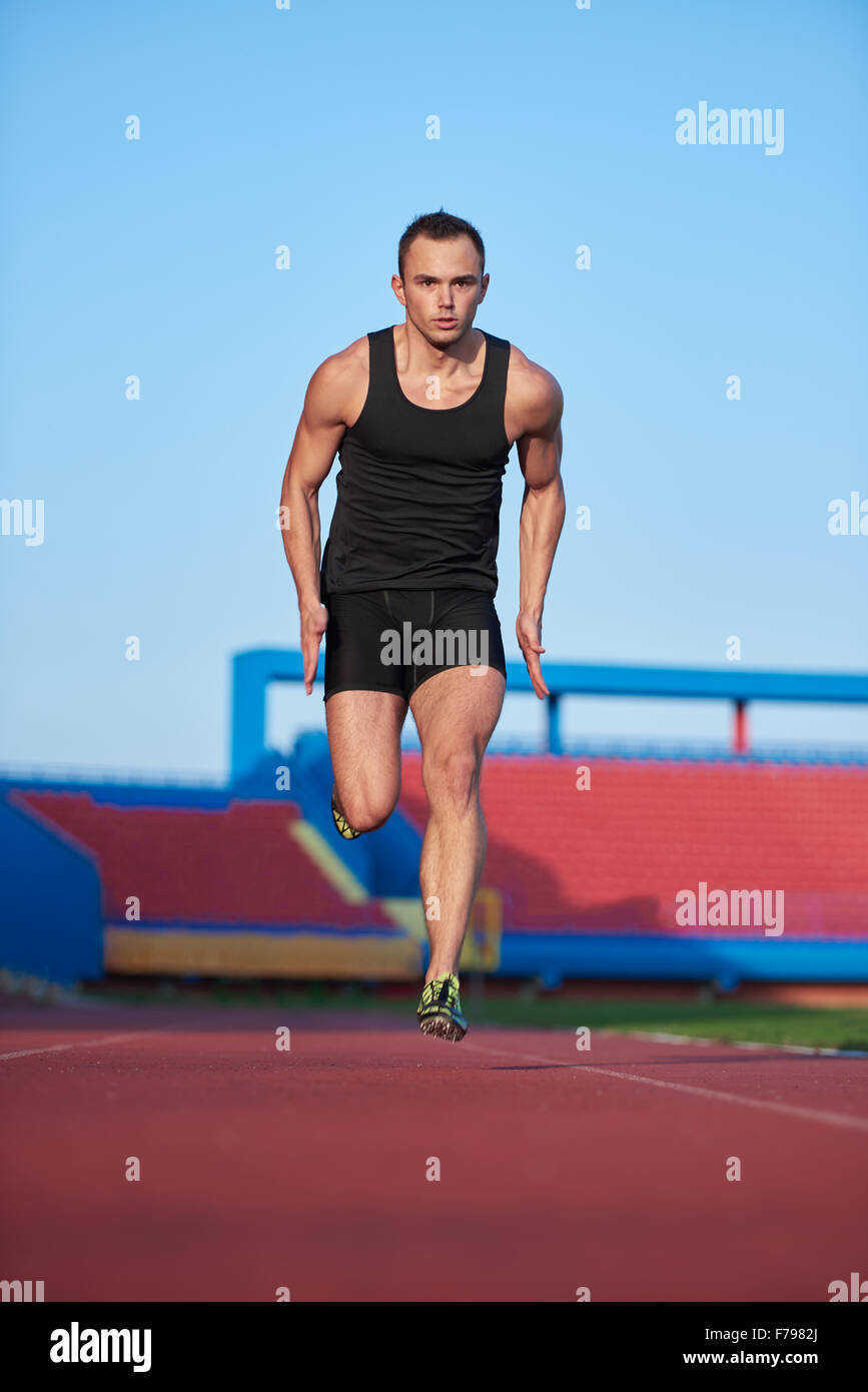Sprinter leaving starting blocks on the running track. Explosive start ...