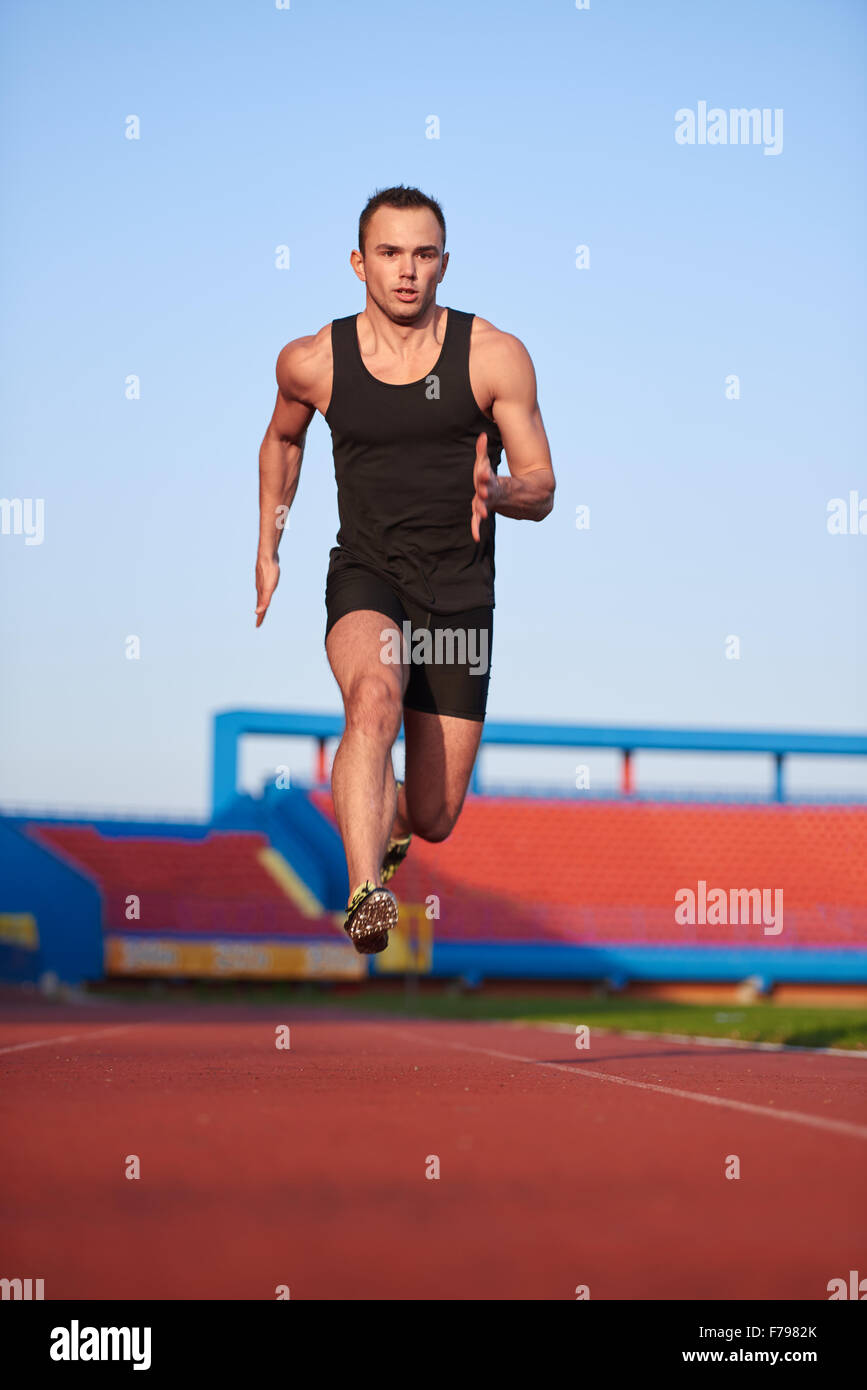 Sprinter leaving starting blocks on the running track. Explosive start ...