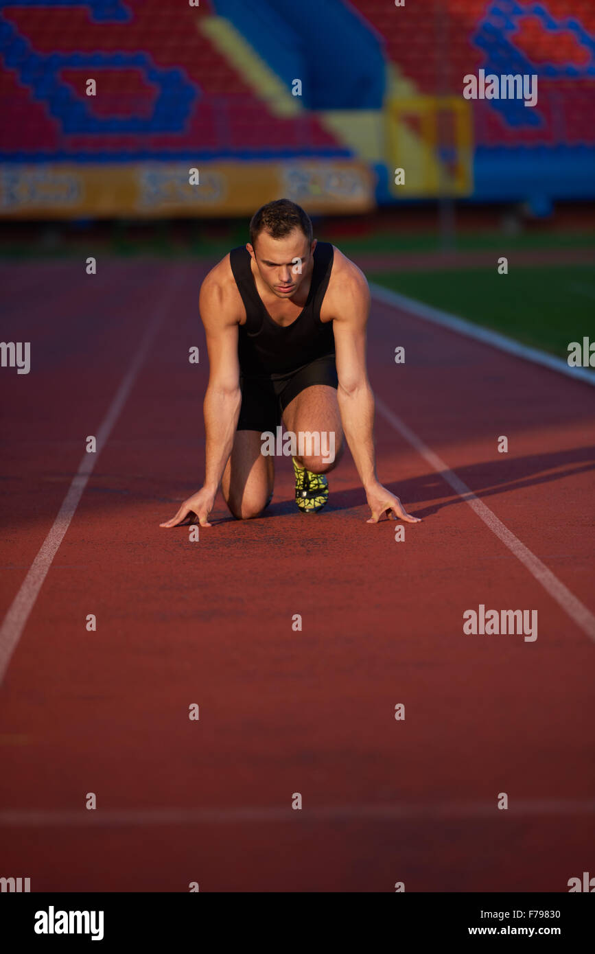 Sprinter leaving starting blocks on the running track. Explosive start ...