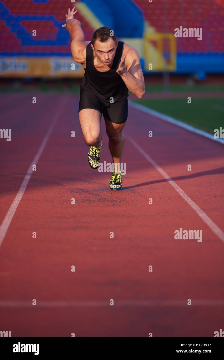 Sprinter leaving starting blocks on the running track. Explosive start ...