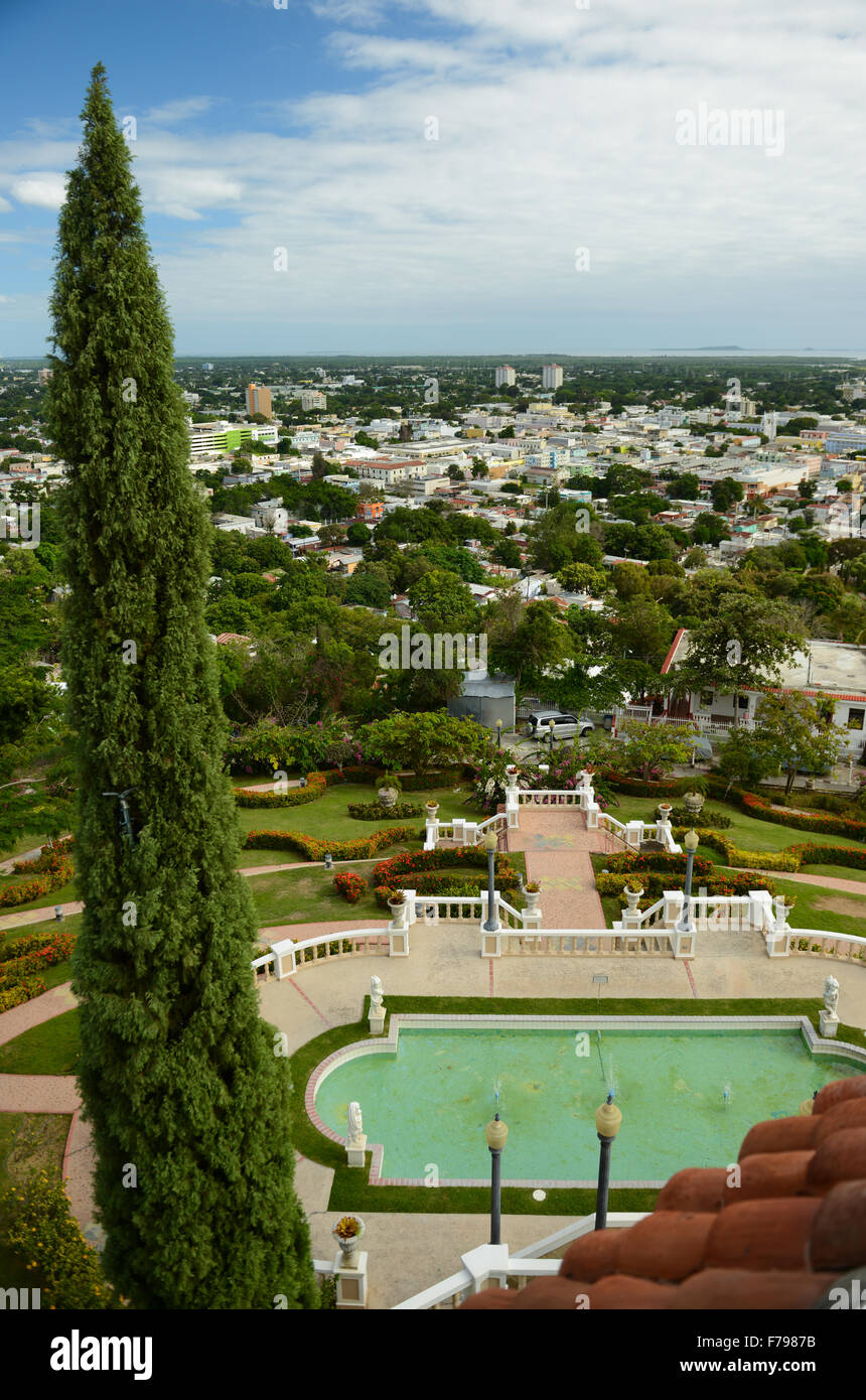 View of a water fountain at the Serralles Castle with the town of Ponce ...