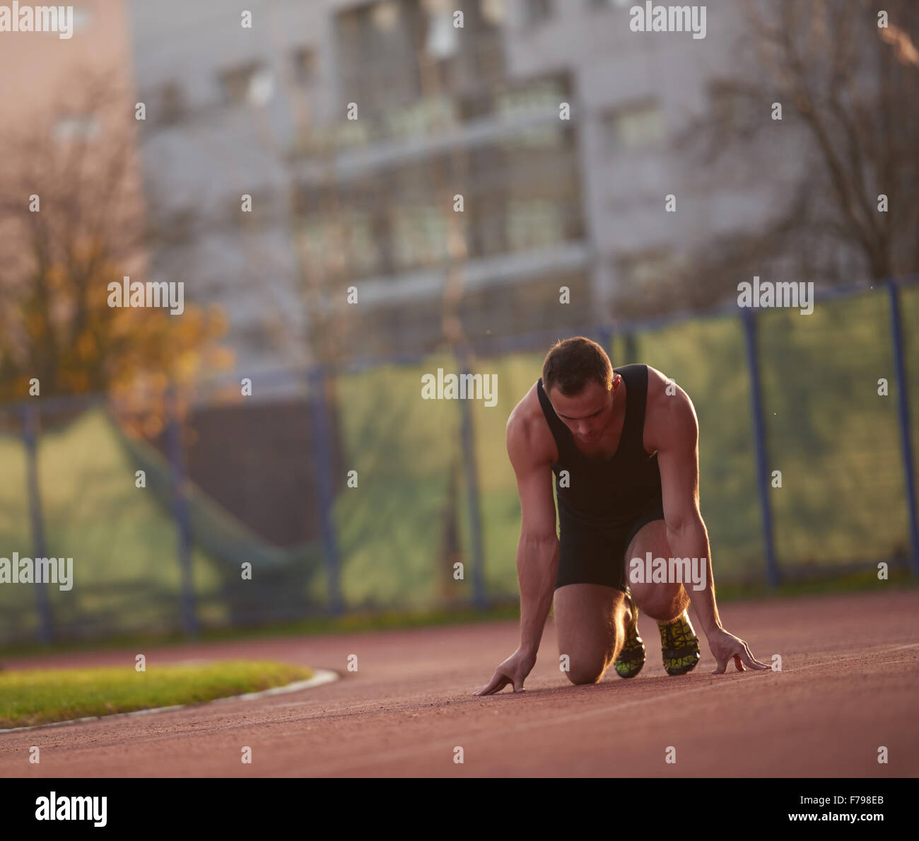 Sprinter leaving starting blocks on the running track. Explosive start ...