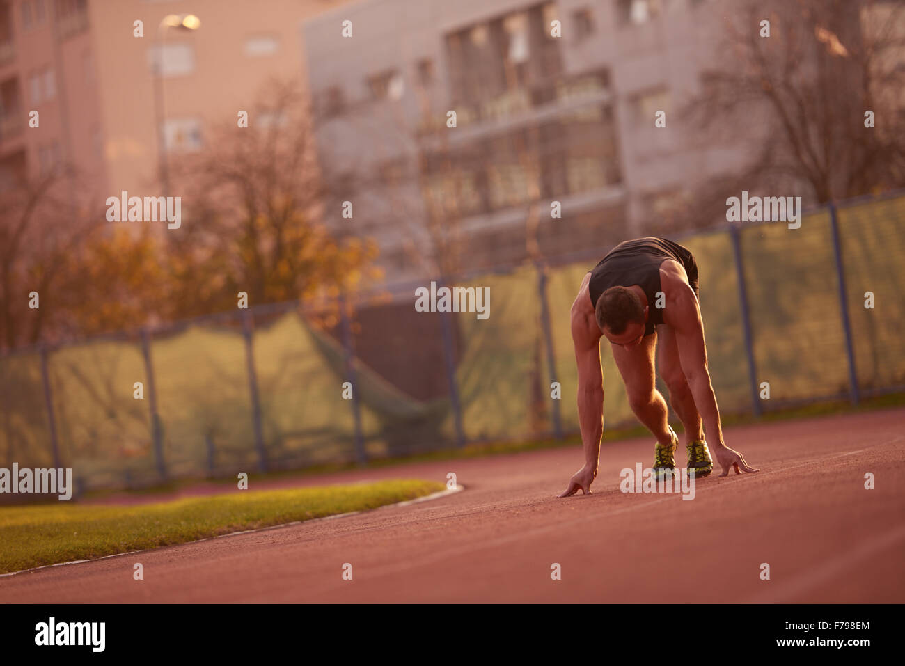 Sprinter leaving starting blocks on the running track. Explosive start ...