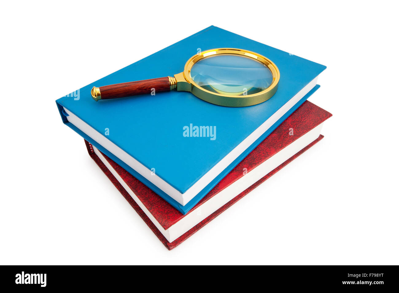 Magnifying glass over the stack of books Stock Photo - Alamy
