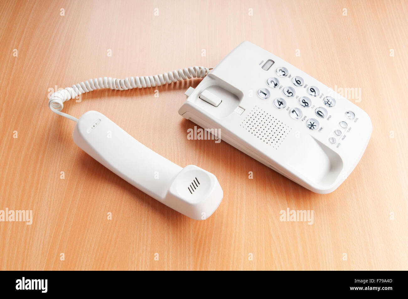 White office phone on the flat surface Stock Photo - Alamy