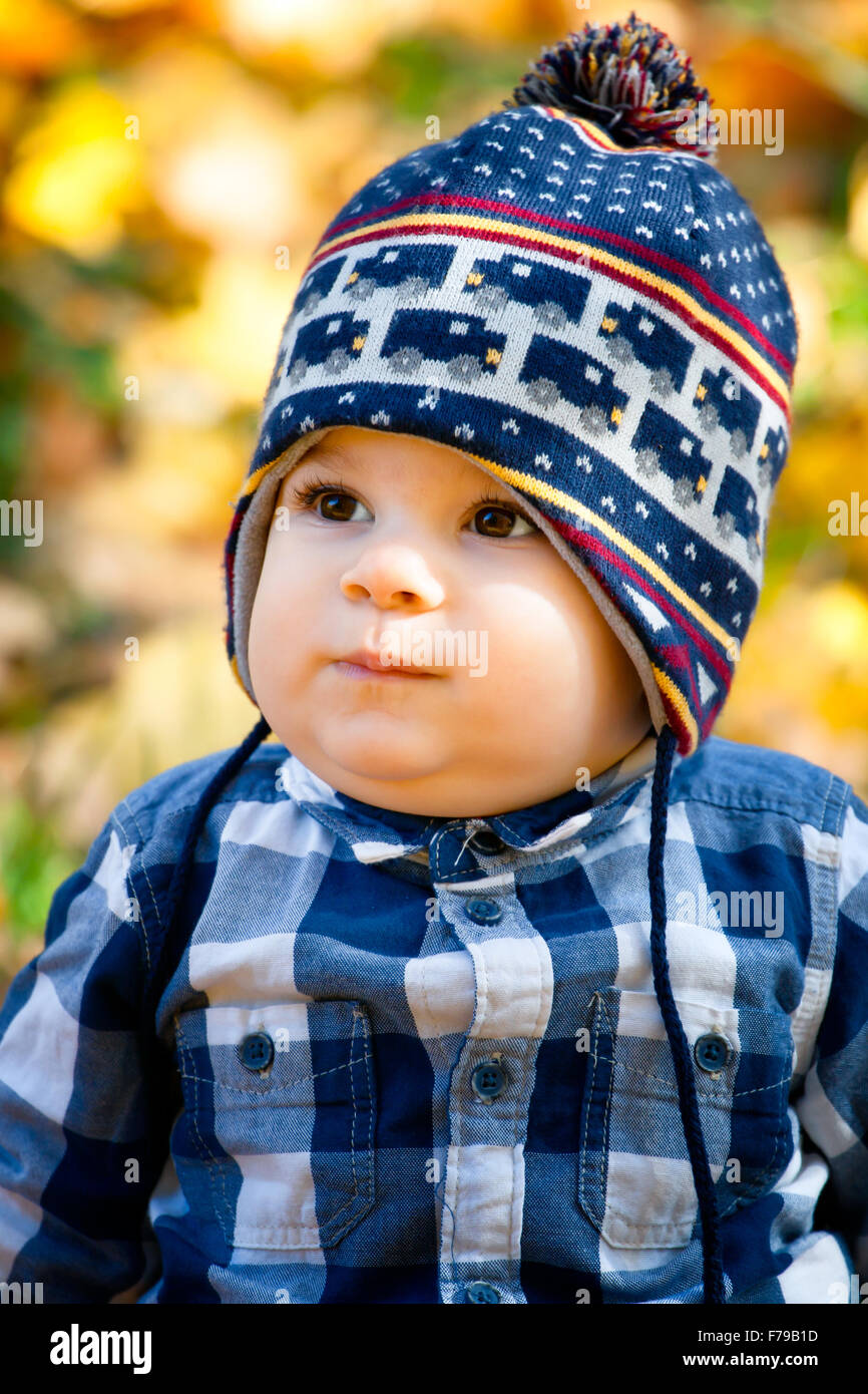 Portrait of 8 months old baby boy enjoying a fall day in the park ...