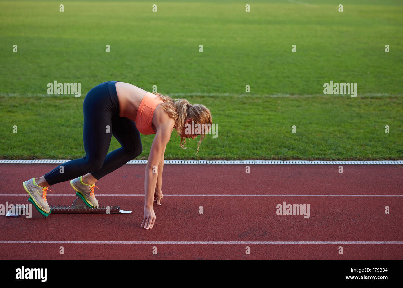 Female sprinter leaving starting blocks hi-res stock photography and ...