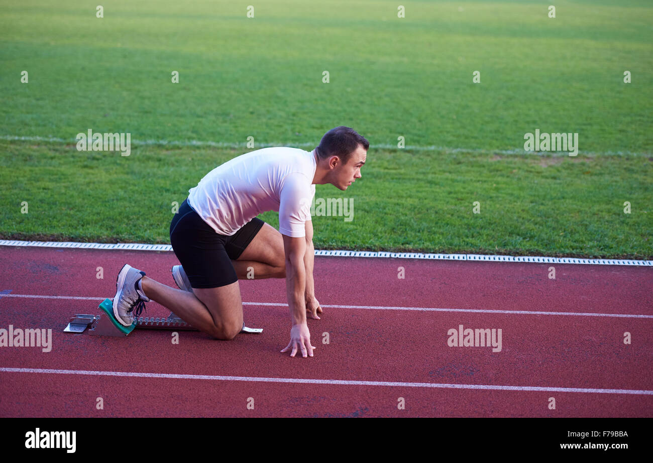 Sprinter leaving starting blocks on the running track. Explosive start ...