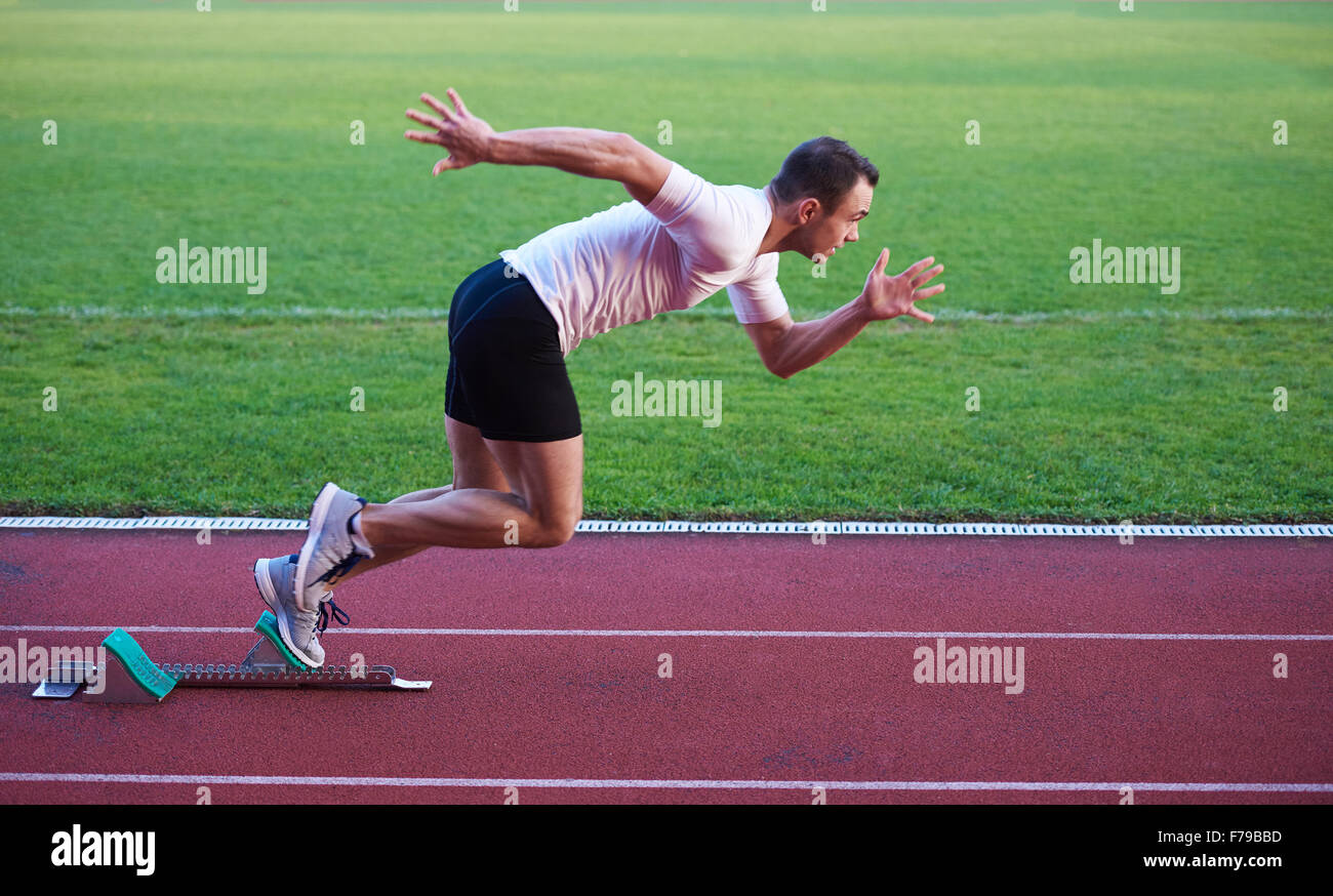 Sprinter leaving starting blocks on the running track. Explosive start ...
