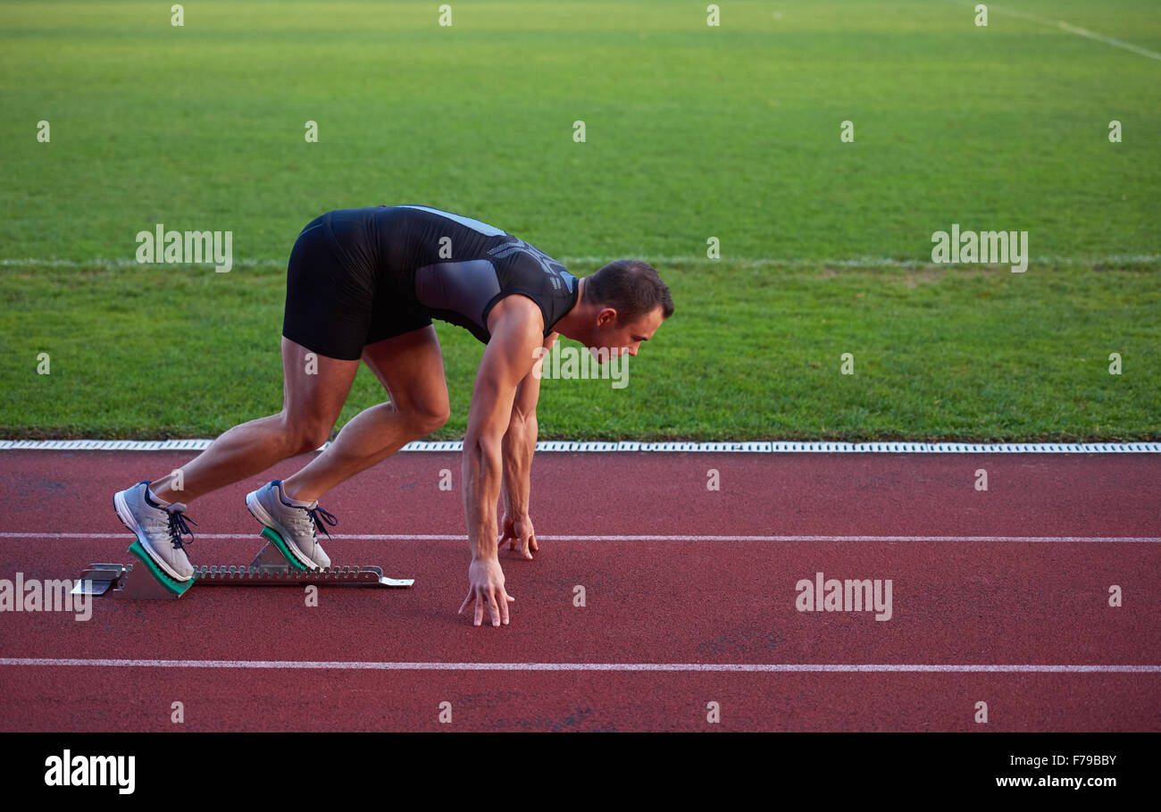 Sprinter leaving starting blocks on the running track. Explosive start ...