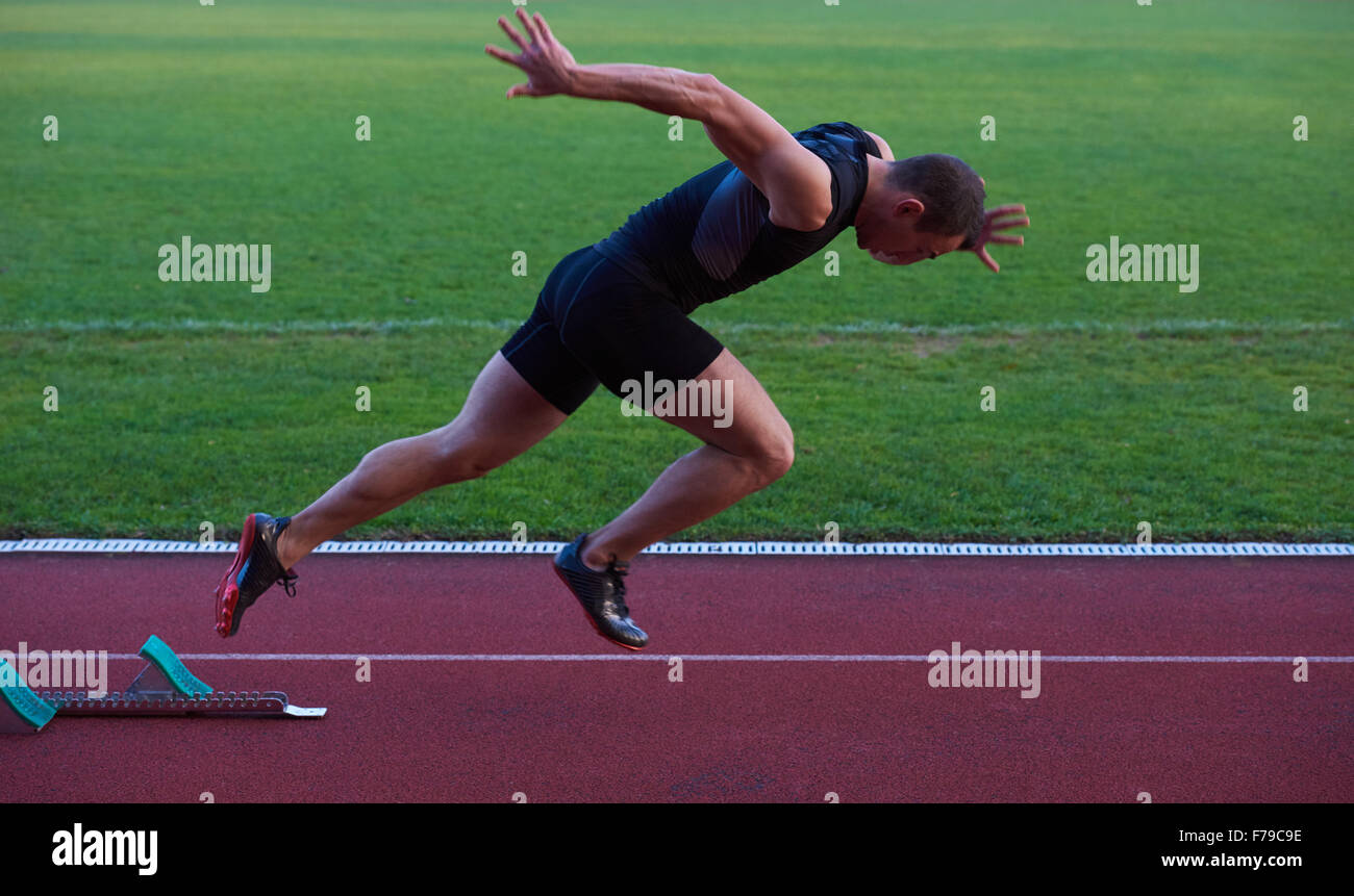 Sprinter leaving starting blocks on the running track. Explosive start ...