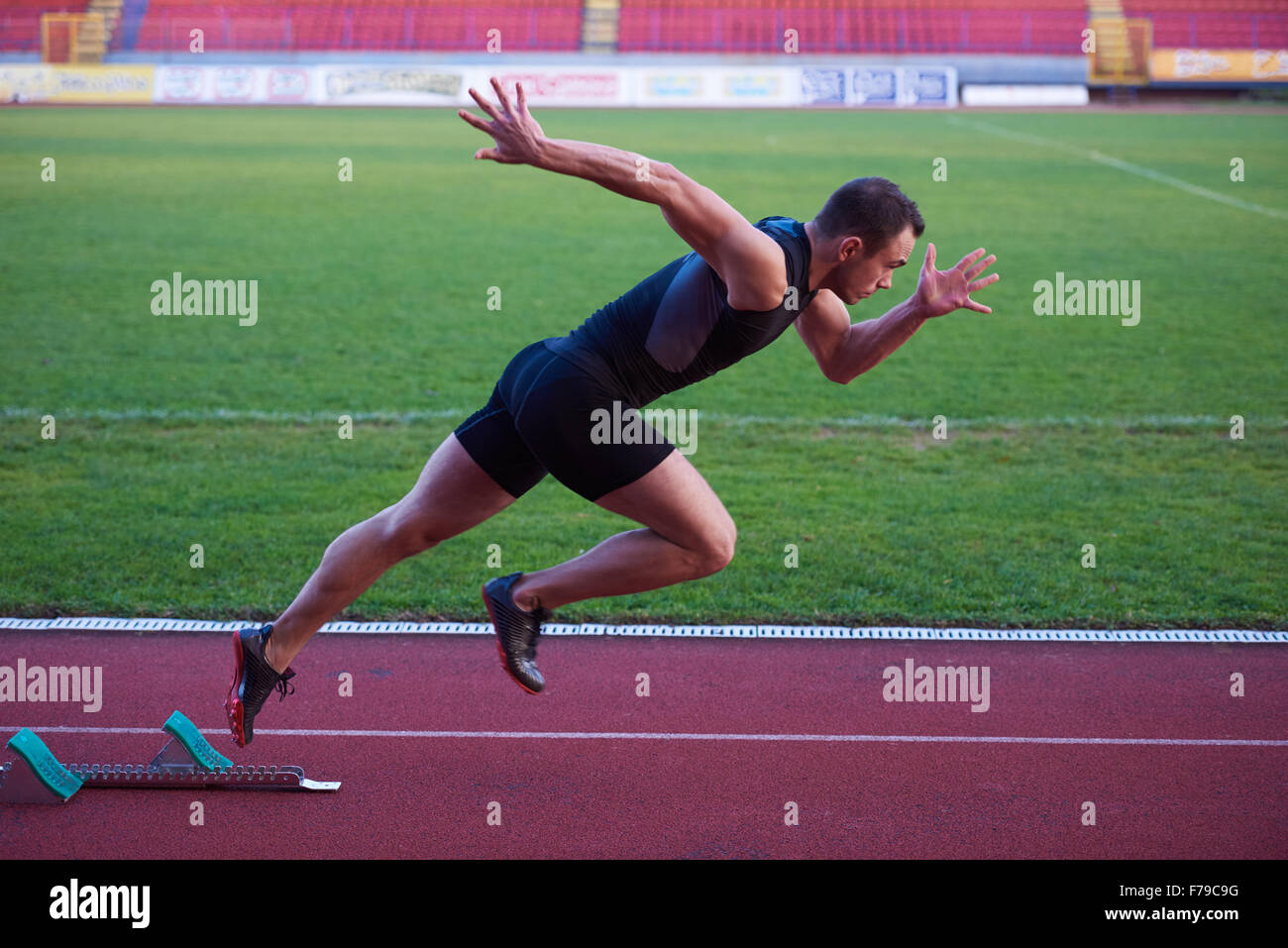 Sprinter leaving starting blocks on the running track. Explosive start ...