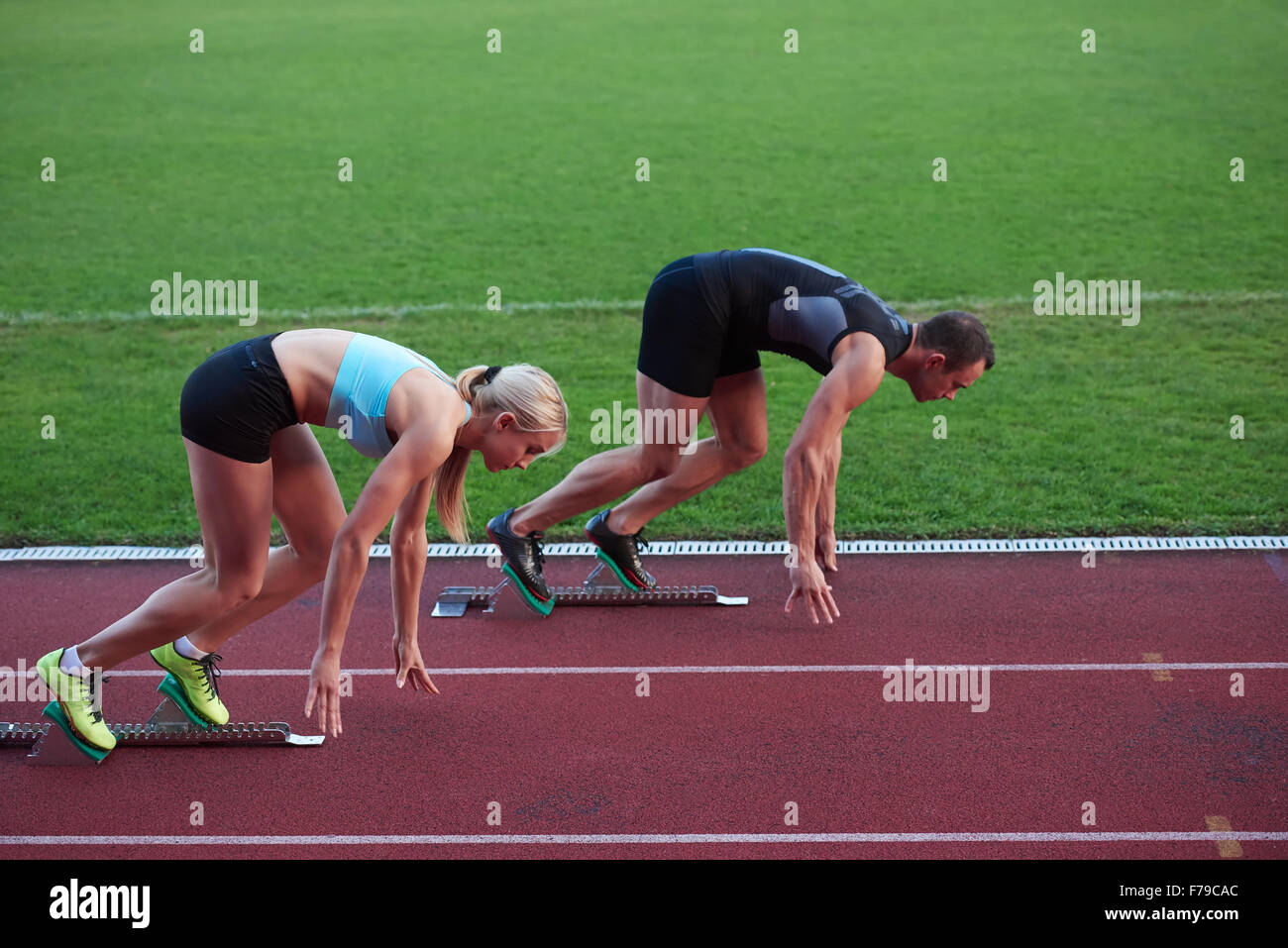athlete woman group running on athletics race track on soccer stadium ...