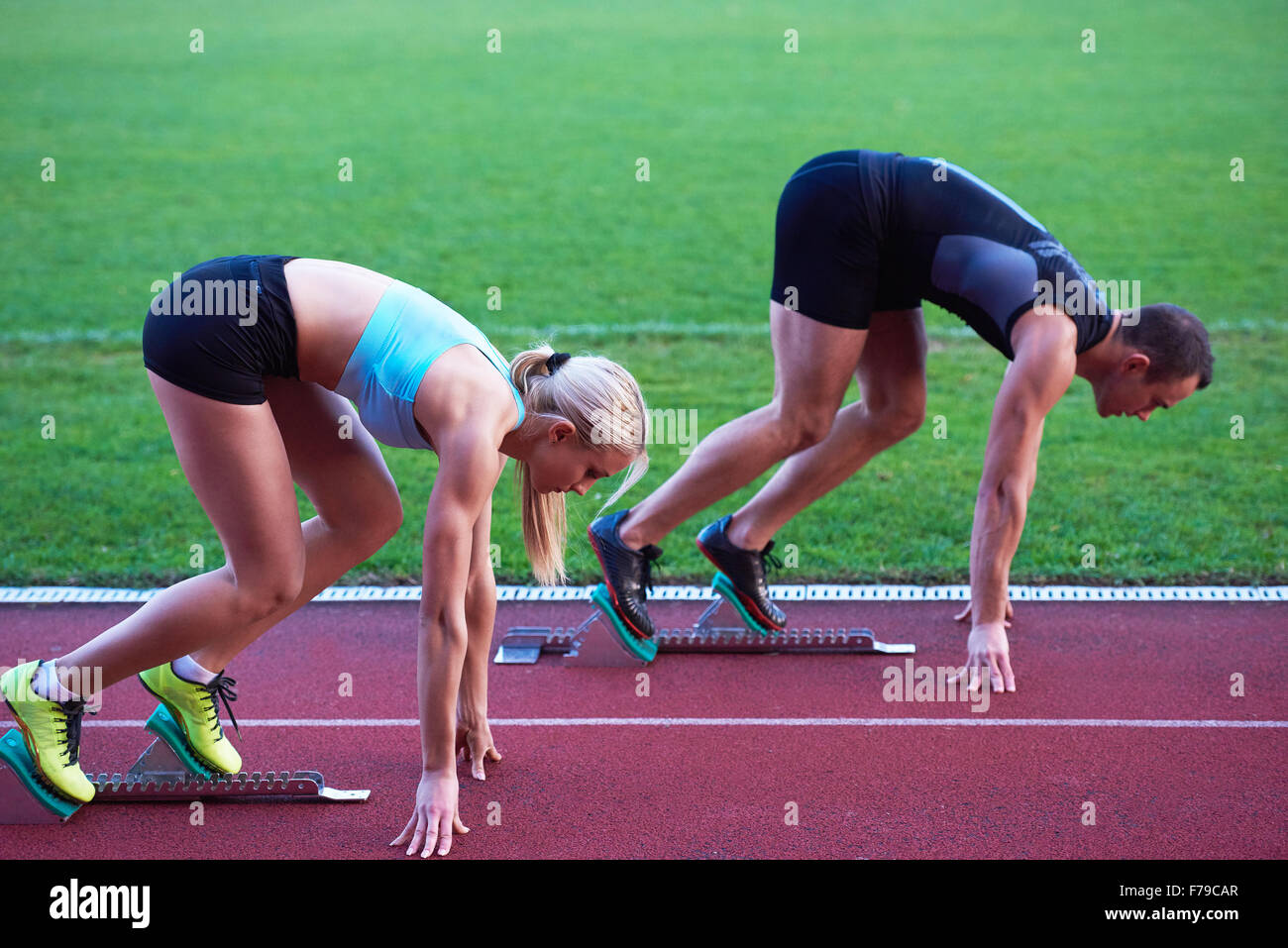 athlete woman group running on athletics race track on soccer stadium ...