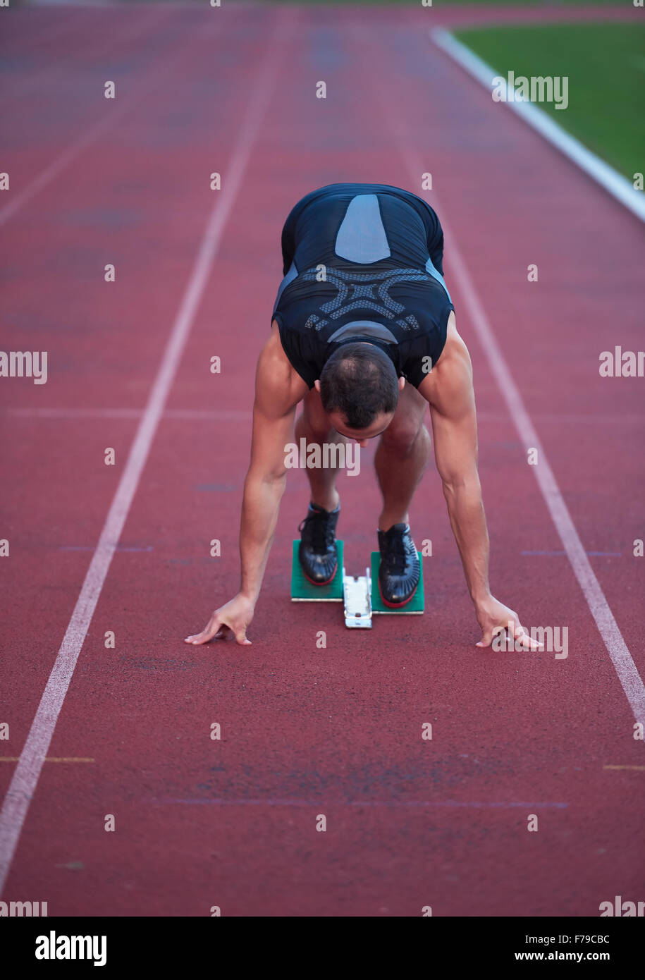 Sprinter leaving starting blocks on the running track. Explosive start ...