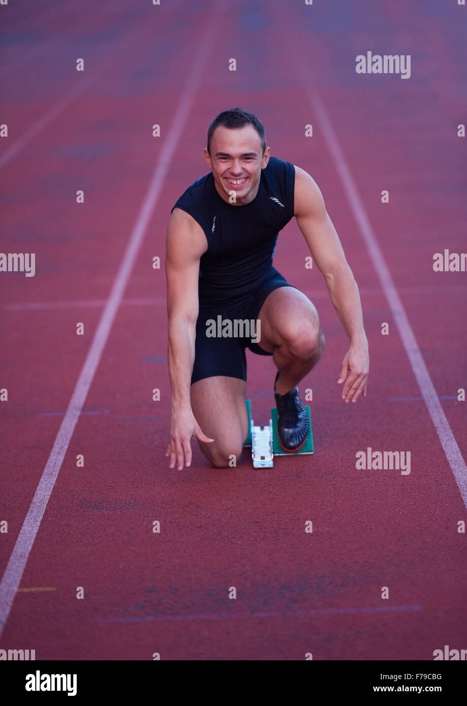 Sprinter leaving starting blocks on the running track. Explosive start ...