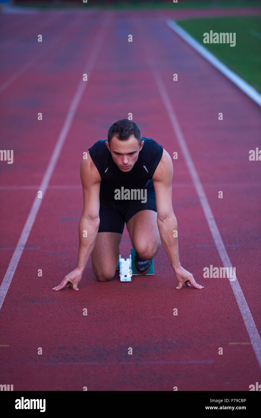 Sprinter leaving starting blocks on the running track. Explosive start ...