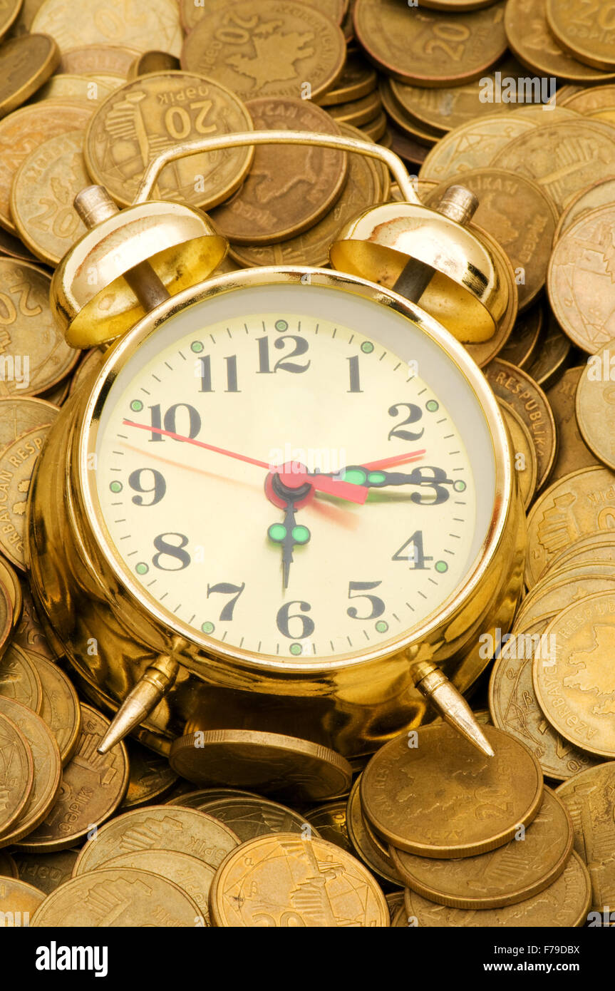 Time is money concept with clock and coins Stock Photo - Alamy