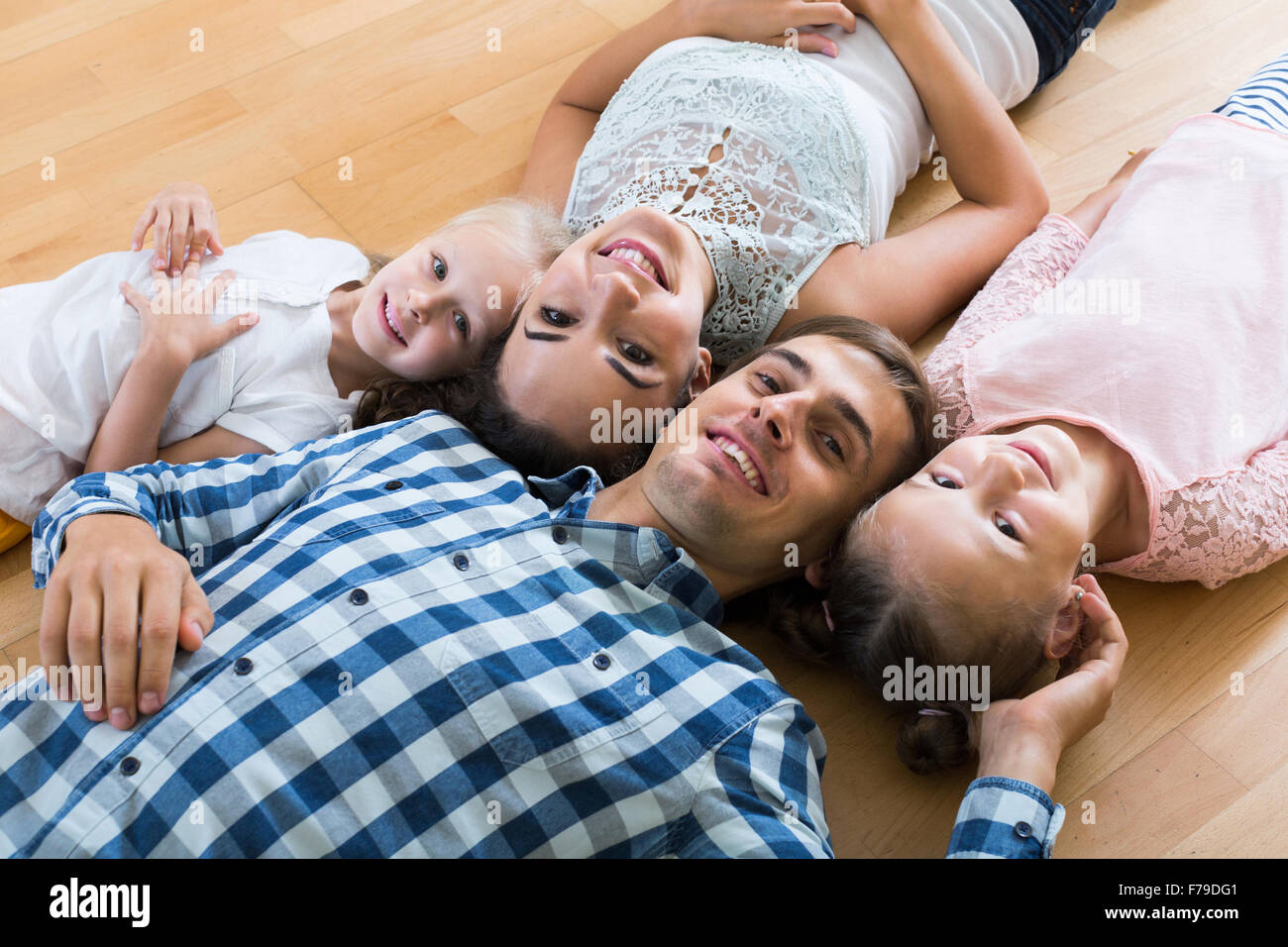 Family values: portrait of positive russian parents with little girls ...