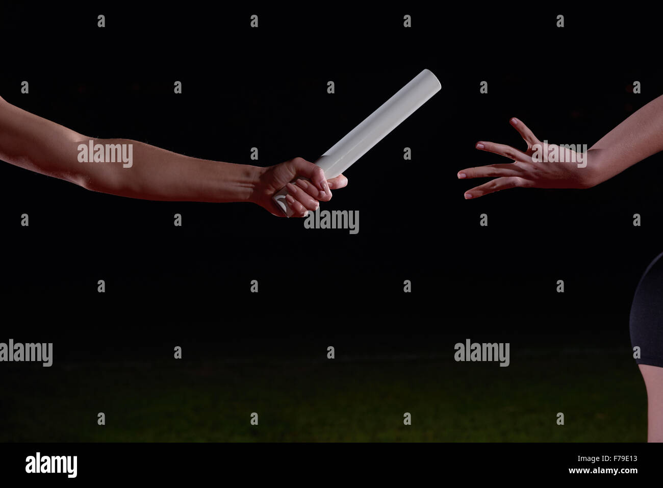 woman athletic runners passing baton in relay race Stock Photo - Alamy