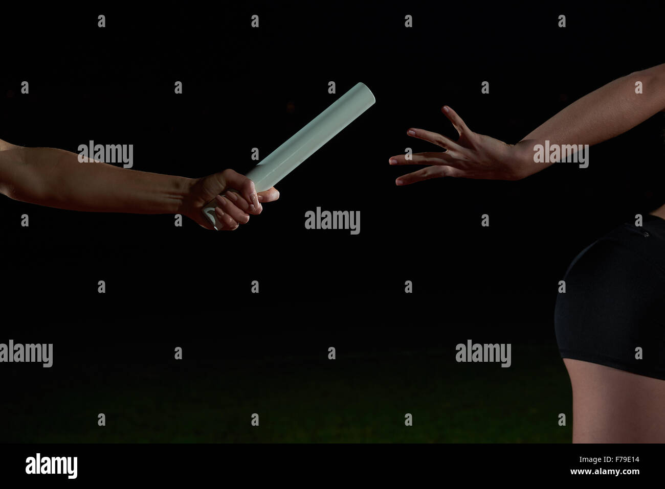 woman athletic runners passing baton in relay race Stock Photo - Alamy