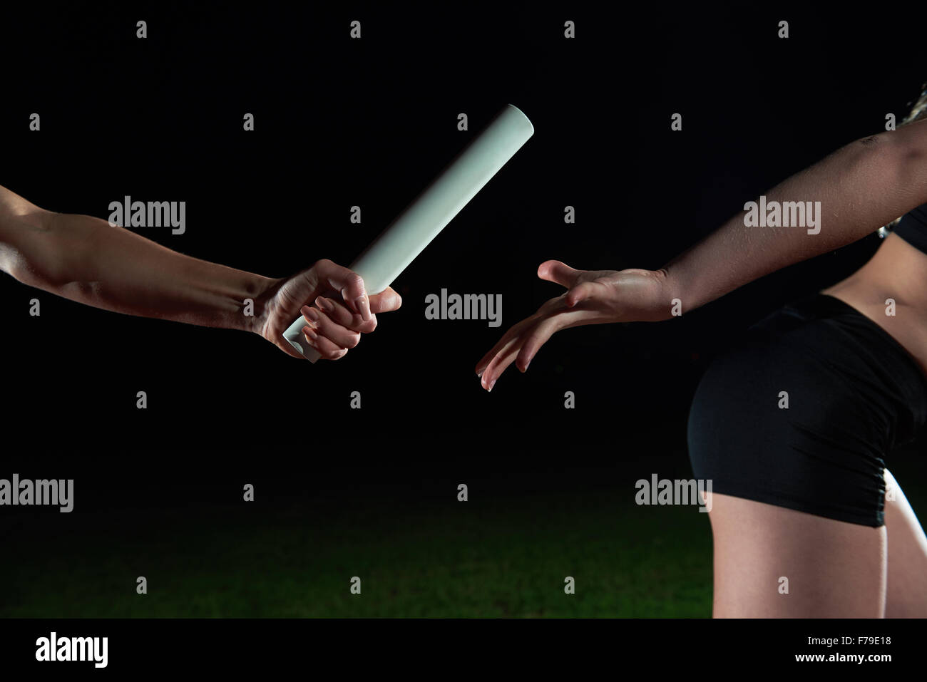 woman athletic runners passing baton in relay race Stock Photo - Alamy