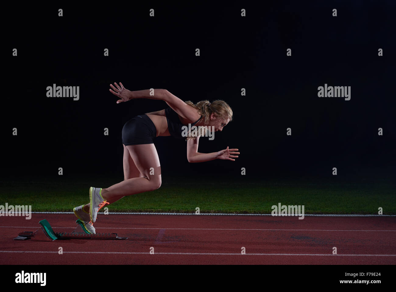 Woman sprinter leaving starting blocks hi-res stock photography and ...