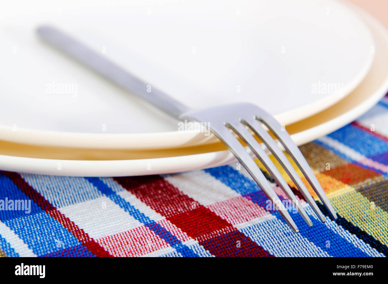Empty plate with utensils Stock Photo - Alamy