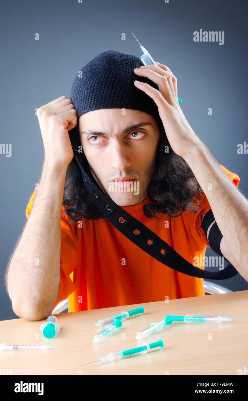 Young druc addict with syringe Stock Photo - Alamy