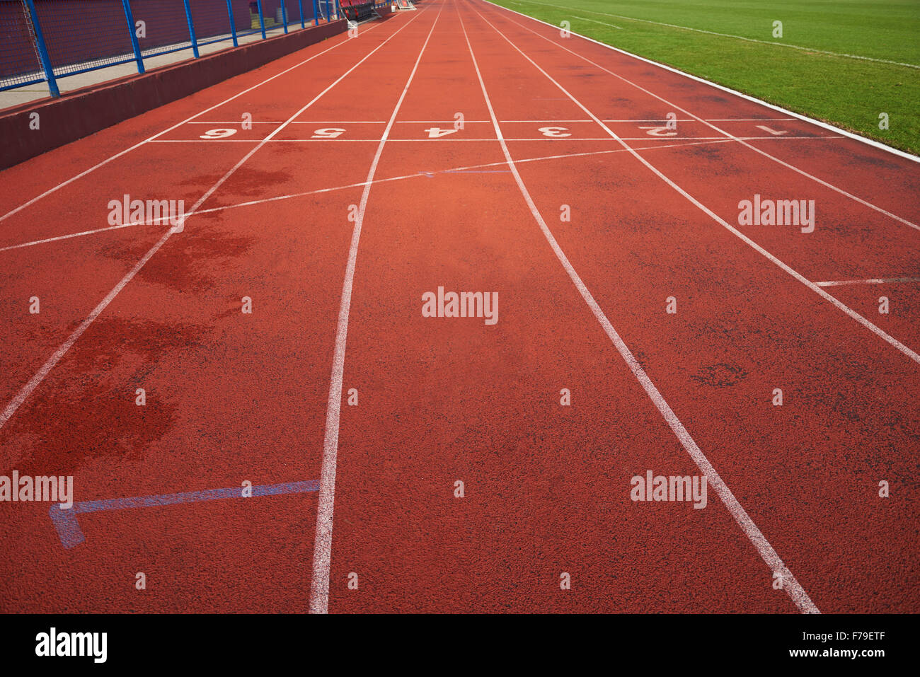 Red athletic track treadmill at the stadium with the numbering Stock ...