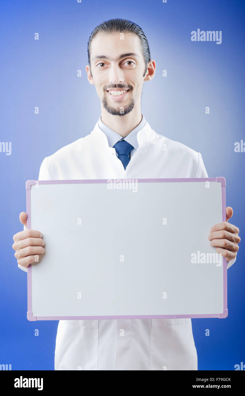 Doctor with blank message board Stock Photo - Alamy
