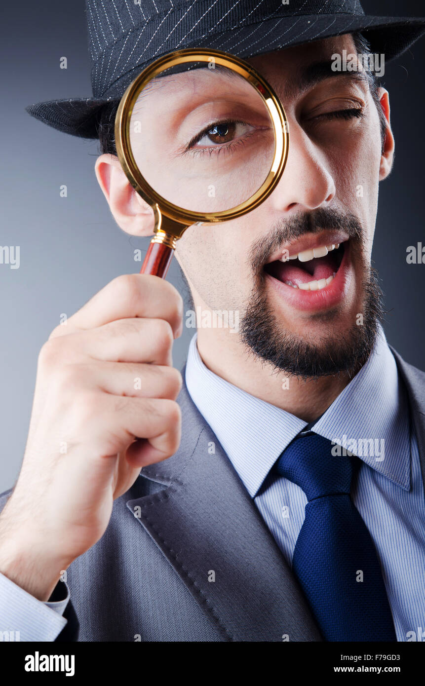 Detective and magnifying glass Stock Photo - Alamy