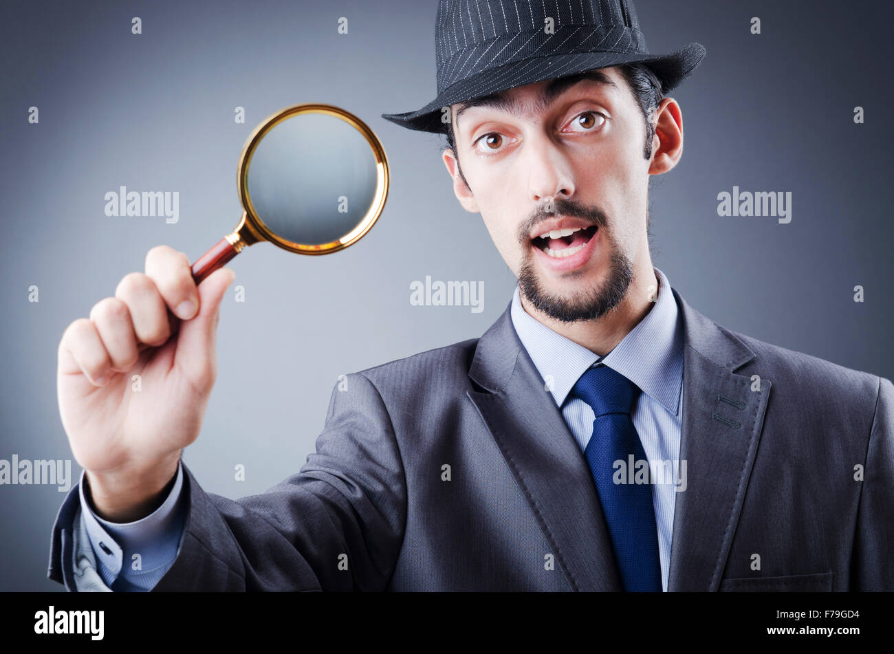 Detective and magnifying glass Stock Photo - Alamy
