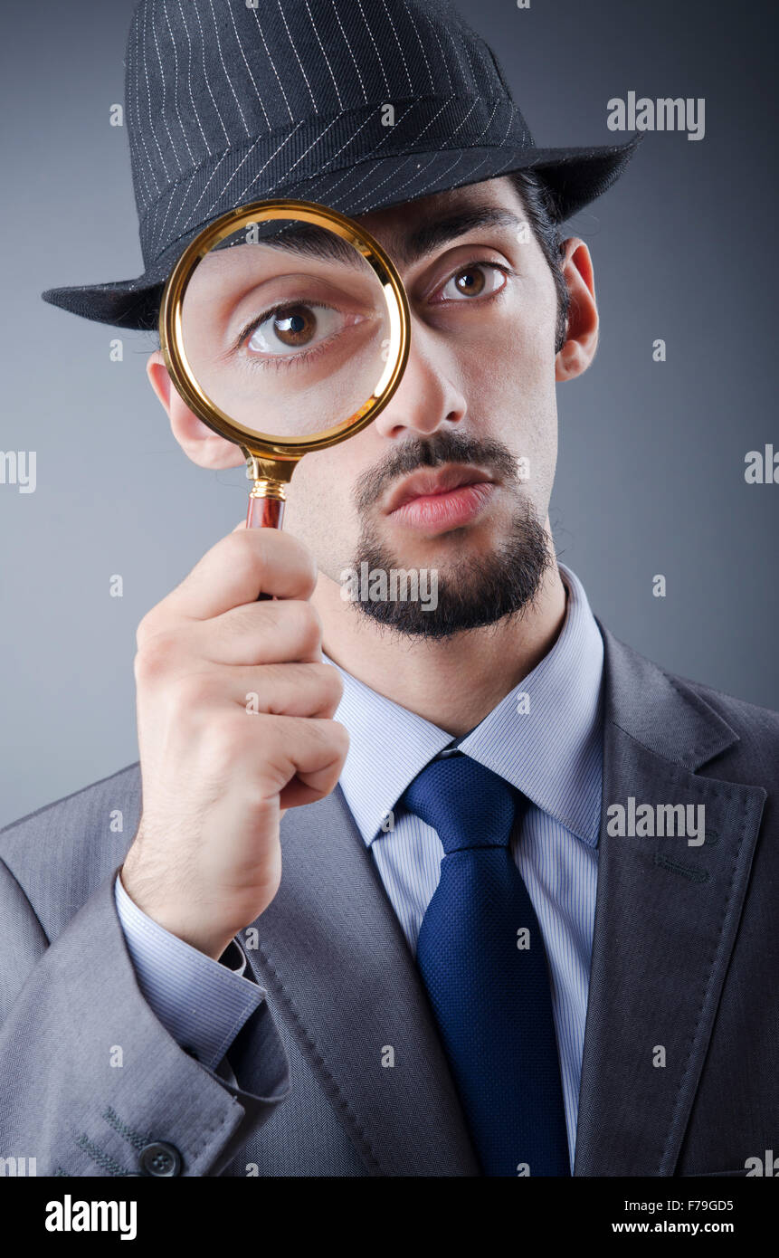 Detective and magnifying glass Stock Photo - Alamy