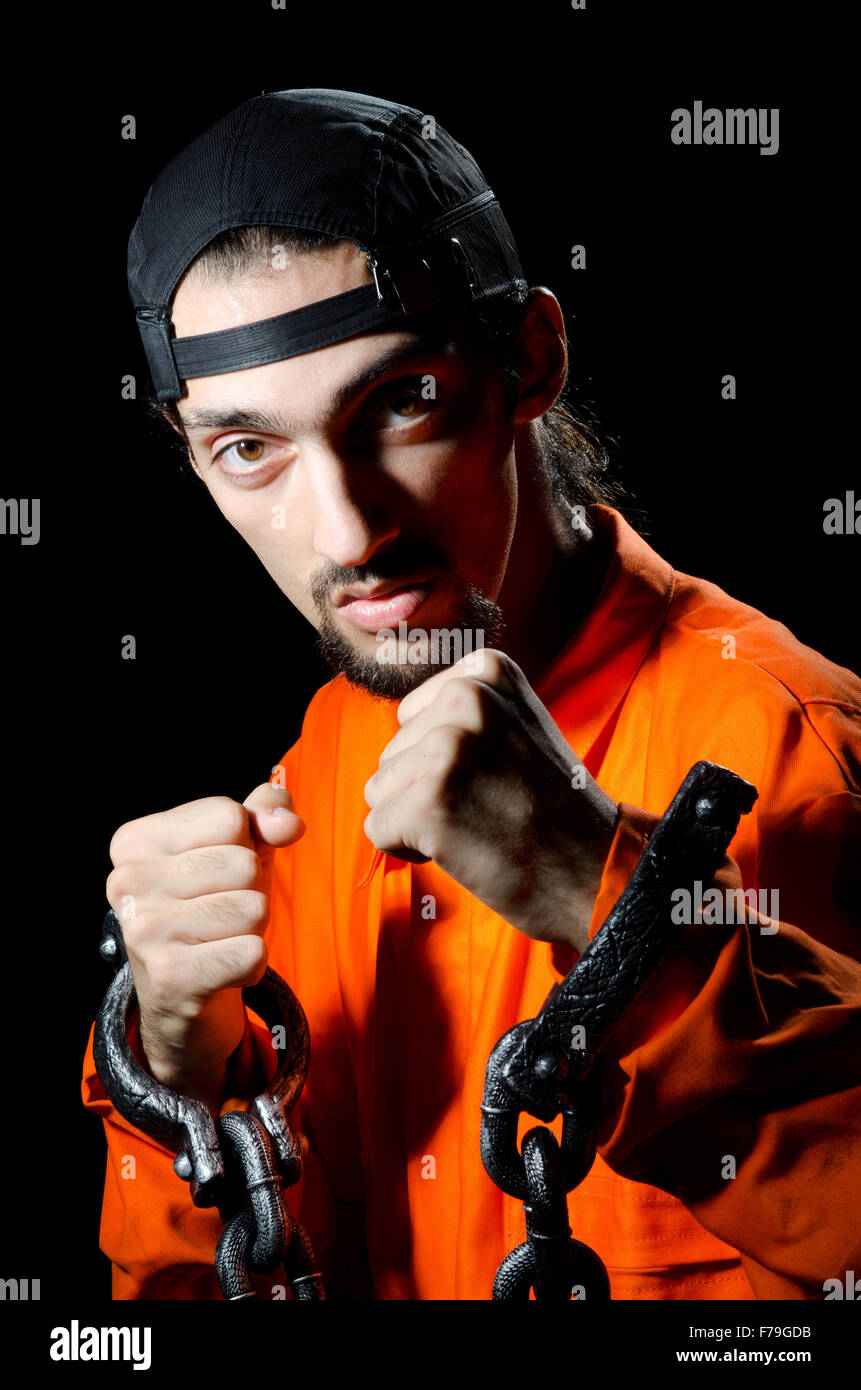 Inmate chained on black background Stock Photo - Alamy
